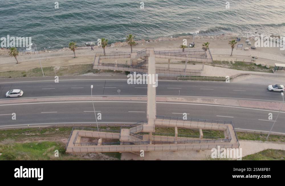 Malaga, Spain: pedestrian overpass bridge near the Mediterranean shore ...
