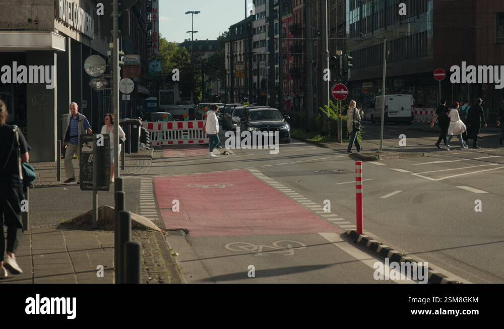 Families and solo people walk commuting across the urban streets in the ...