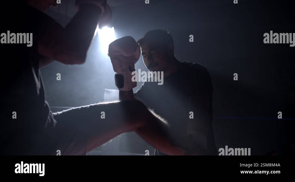 Two fighters face each other inside boxing ring battling in dramatic ...