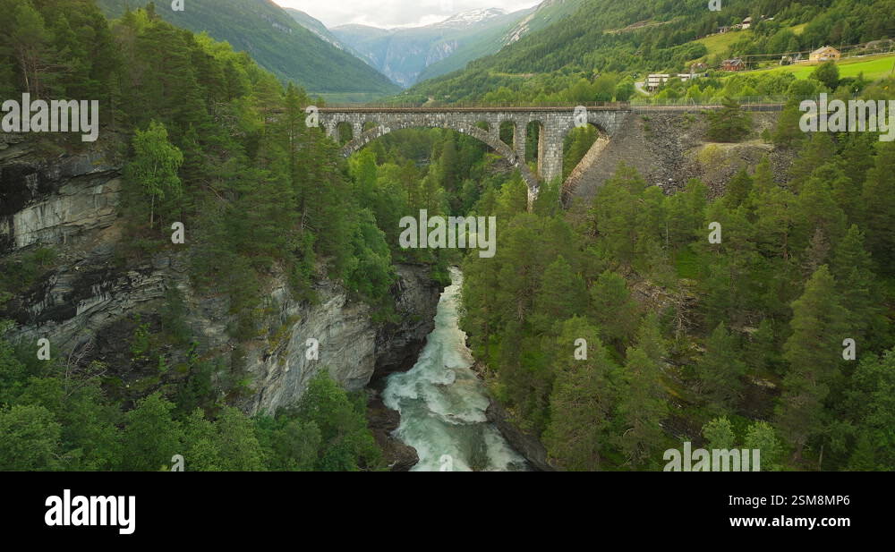 Scenic Kylling stone bridge spanning Rauma river in Romsdalen Valley ...