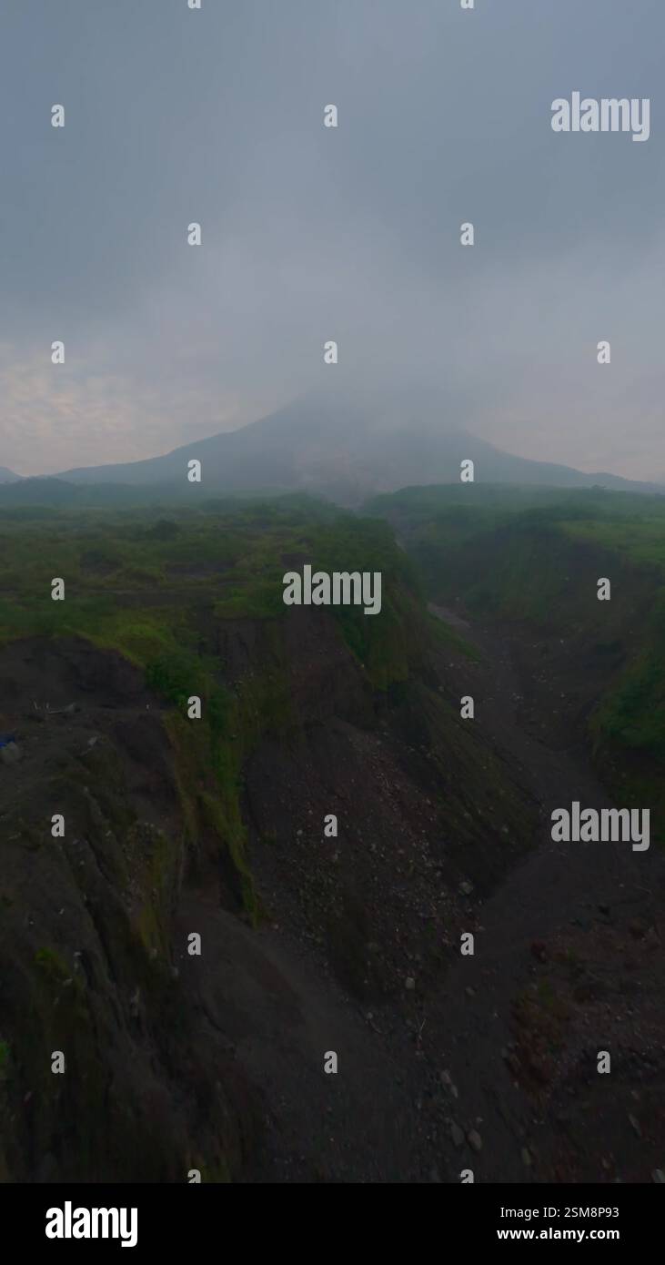 Vertical video. Tropical jungle forest canyon frozen lava smoke active ...