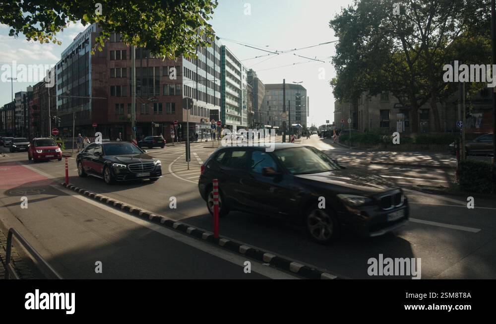 Cyclists races cars in bike path as traffic slows in downtown city at ...
