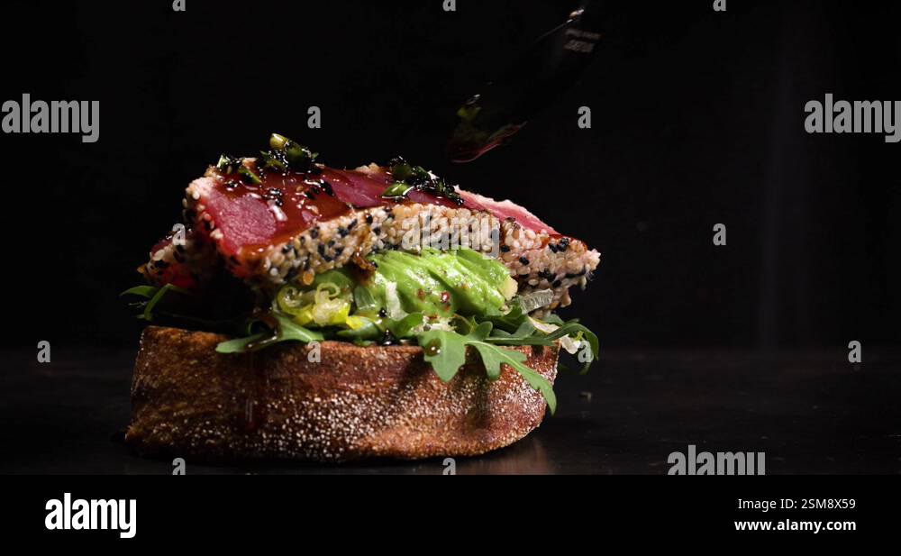 Tuna sandwhich is drizzled with a soy sauce with herbs Stock Video ...