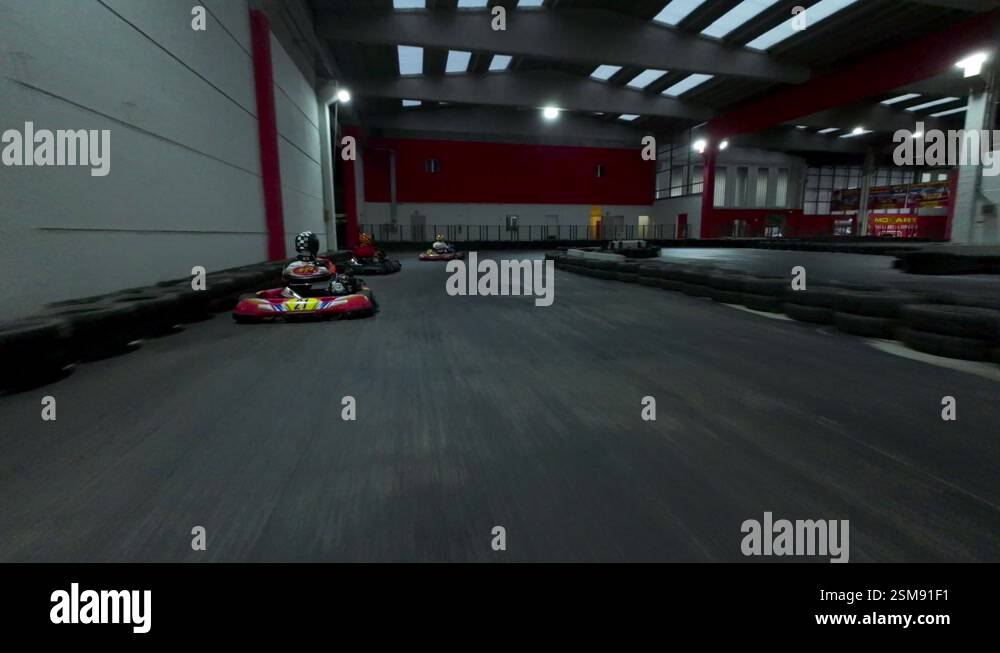 Go-Kart race on indoor and outdoor track seen from racing Fpv Drone ...