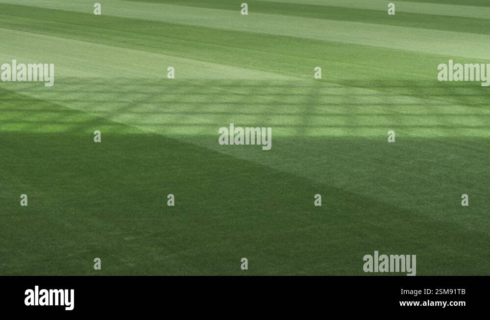Timelapse: shadow of stadium roof and clouds move across grass stadium ...