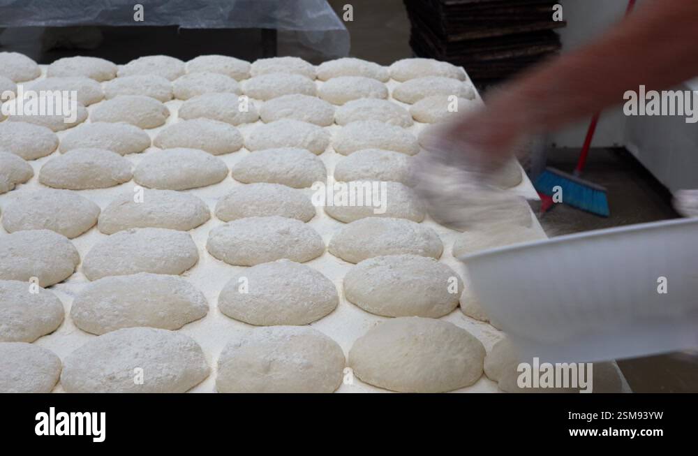 Bakery Worker Dusting Flour on Dough Stock Video Footage - Alamy