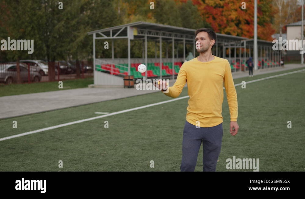 Slender man warming up before friendly pickleball match at stadium ...
