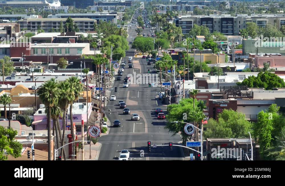 Downtown street with stores and palm trees in Scottsdale, Arizona. Long ...