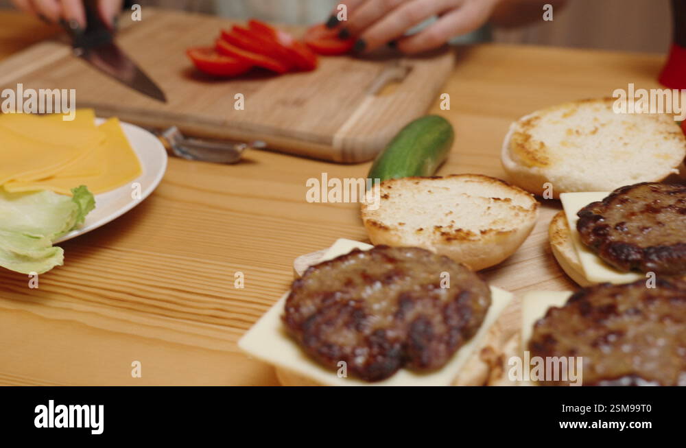 Preparing Homemade Burgers for the Whole Family, a Woman Slices ...