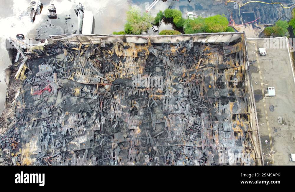 descending above the gutted shell of a chemical factory after fire ...