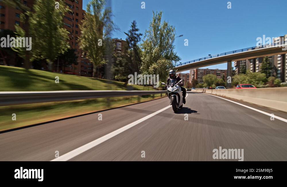 Rolling shot man riding supersport Ducati motorcycle on the street in ...