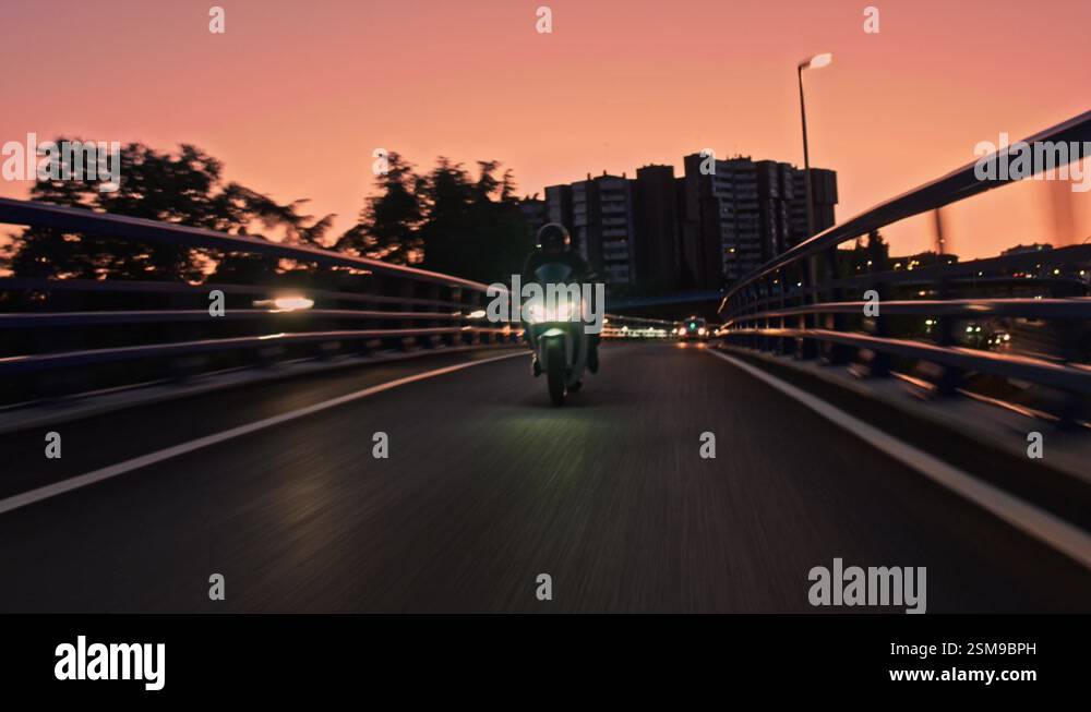 Rolling shot man riding supersport Ducati motorcycle on Madrid street ...