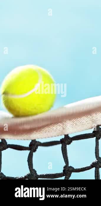 Super slow motion of hitting tennis ball above a net. Low depth of ...