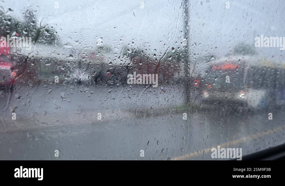 Side window of a bus with raindrops in traffic in the city Stock Video ...