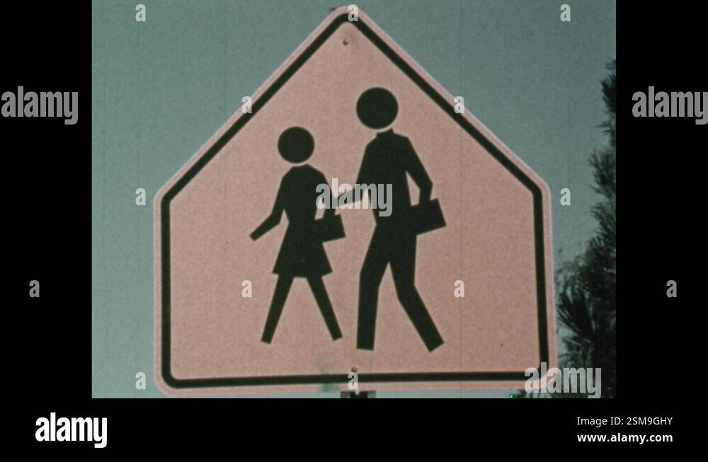 1970s: Close up shots of traffic signs. Tracking shot, girl riding bike ...