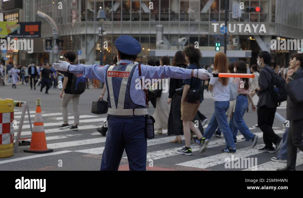 Shibuya Crossing Tokyo Japan, Police Officer directs traffic Stock Video Footage - Alamy