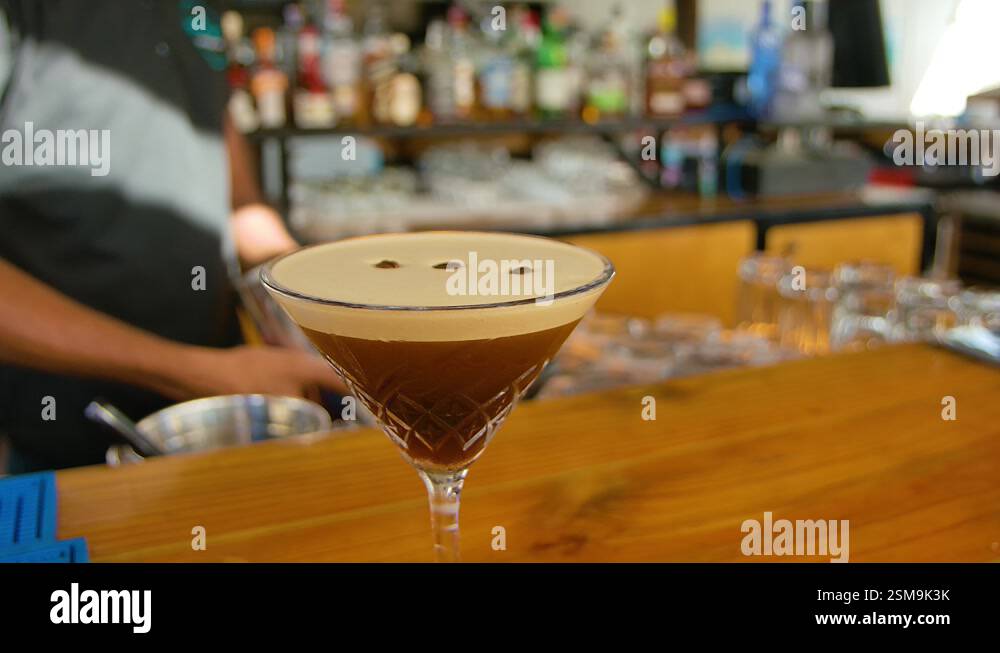 Slow orbit of classic Kahlua espresso on bar top, bartender working in ...