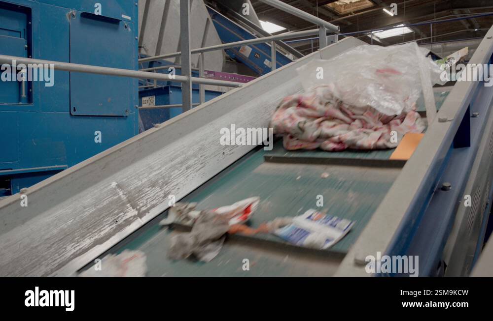 Sorting conveyor belt moving upwards caring out the waste materials ...