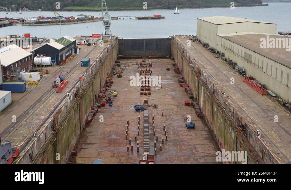 Big empty dry dock in Falmouth shipyard, with industrial equipment and ...