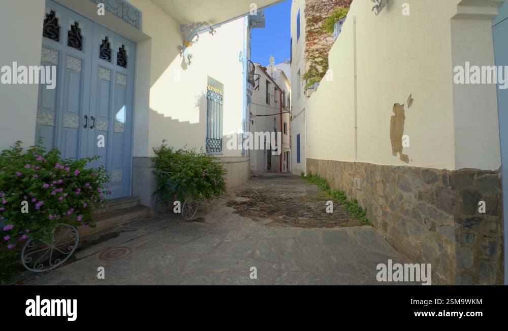 Walking through a Mediterranean town, white, blue windows, Ibizan style ...