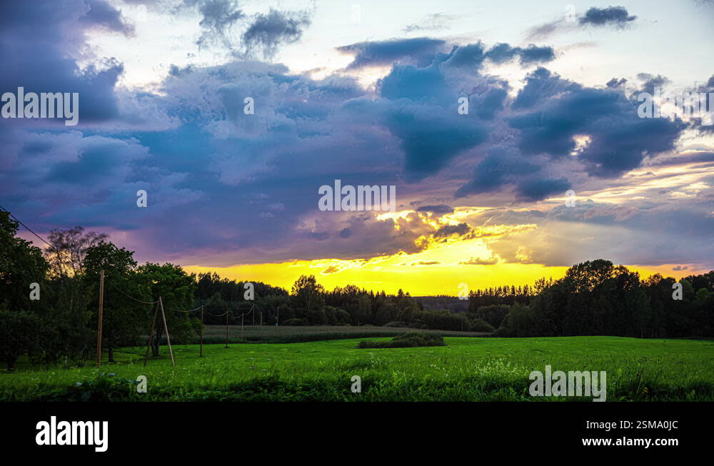 sunset timelapse in green rural field, meadow moving clouds time-lapse ...
