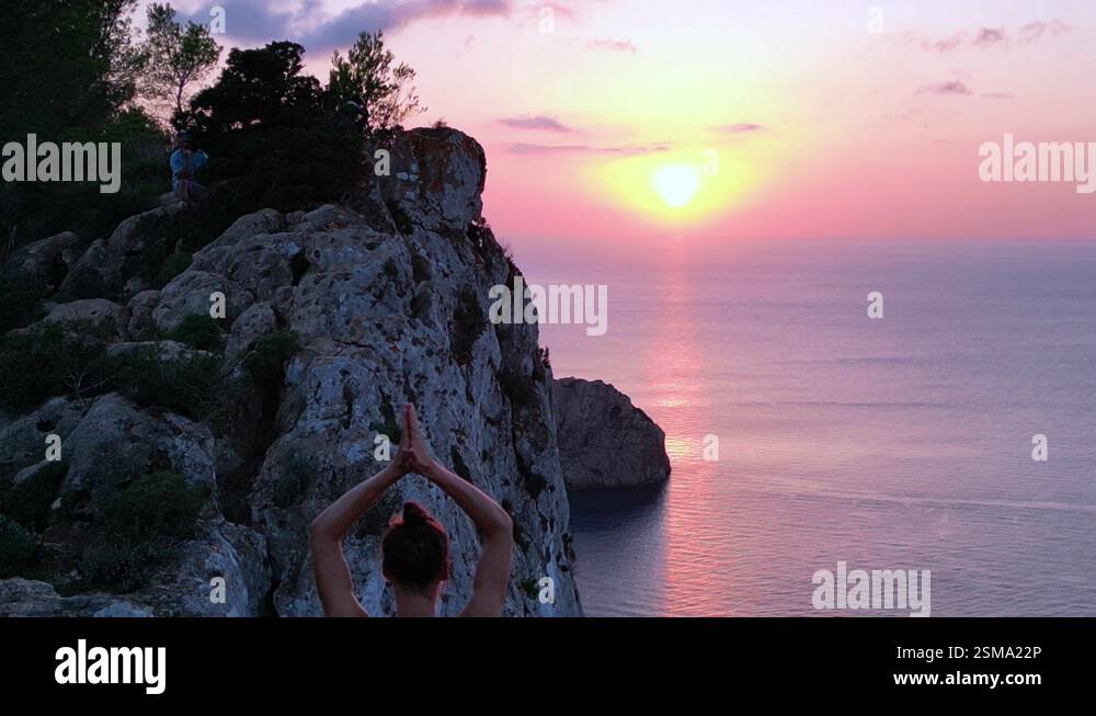Magic aerial top view flight Ibiza cliff Yoga tree pose model girl ...