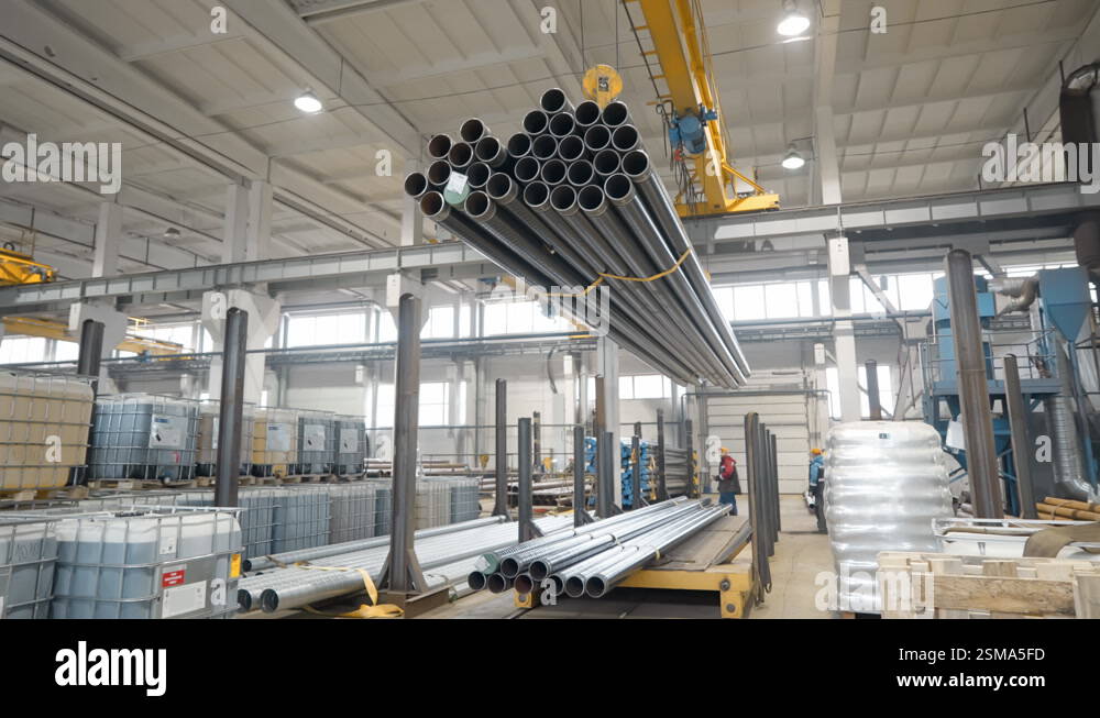 Industrial Crane Machine Lifts Heavy Stack Of Manufactured Pipes In Workshop Stock Video Footage ...