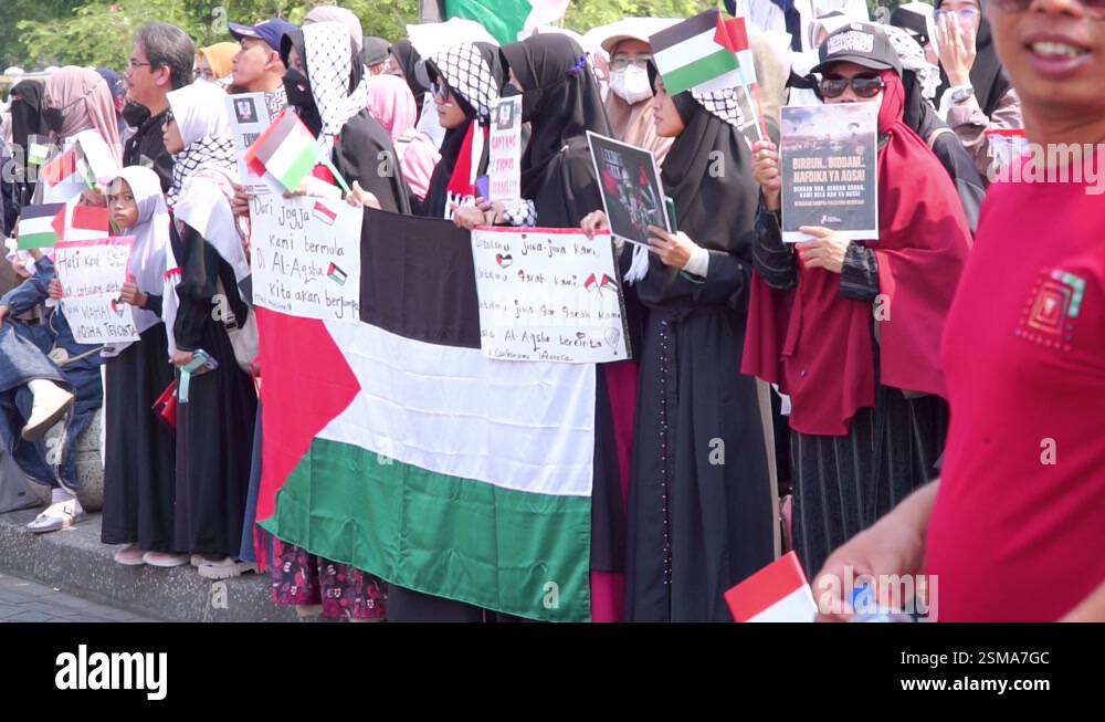 Muslim people holding Palestinian flags and paper saying peace - peace ...