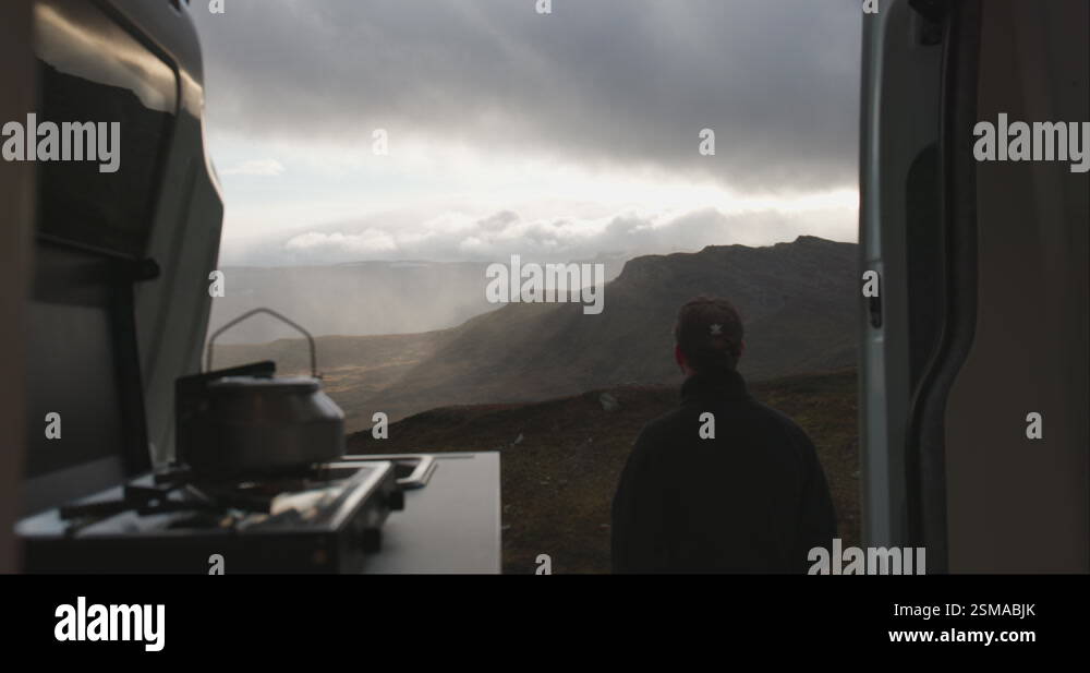 Back of male standing outside open campervan door with Jotunheimen sunset Stock Video Footage ...