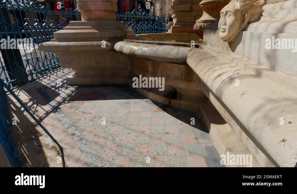 Tilt up of the Muristan fountain running trickle of water, Old City ...