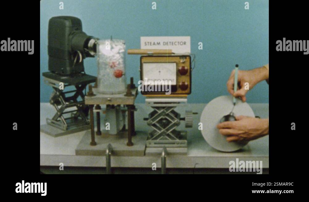 1980s: Science experiment for boiling point of water. Person marks ...