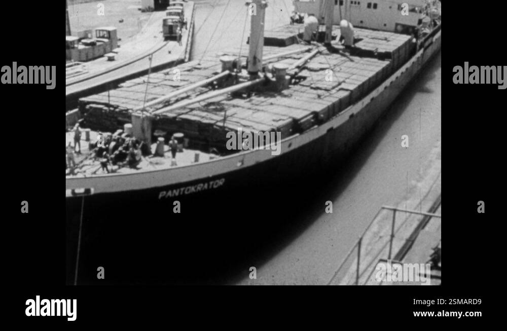 1960s: Tow car pulls large ship through canal. Model ship connected to ...