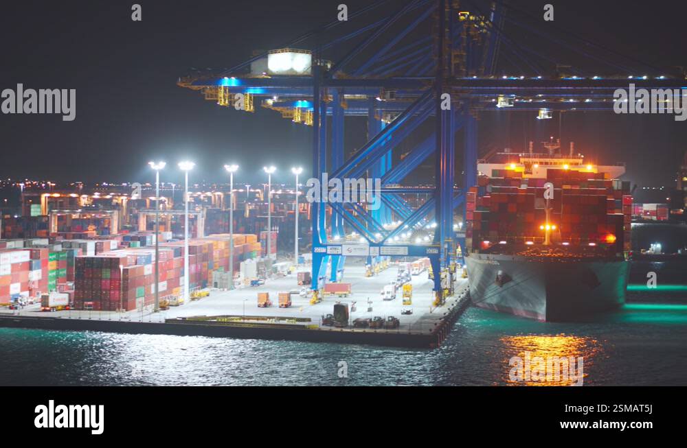 4k, panoramic aerial night view, Port cranes and many containers in the ...