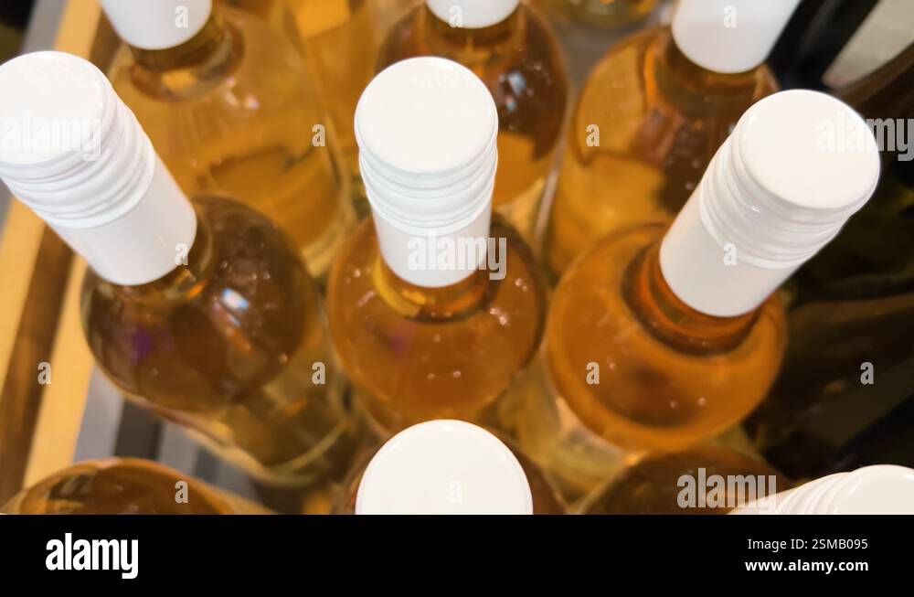 Top down view of rose wine bottles line up on the shelf of an ABC store ...