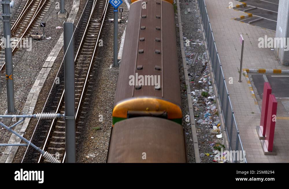 A multi-car train running on a railroad viewed in high angle showing ...