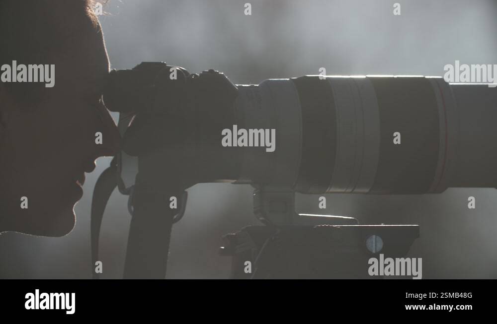 close up pan of woman looking through DSLR camera eye piece Stock Video ...