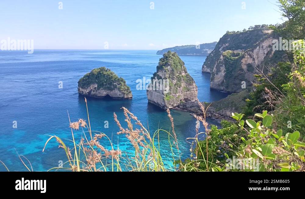 Pan shot of stunning hidden beach located at the bottom of a sheer ...