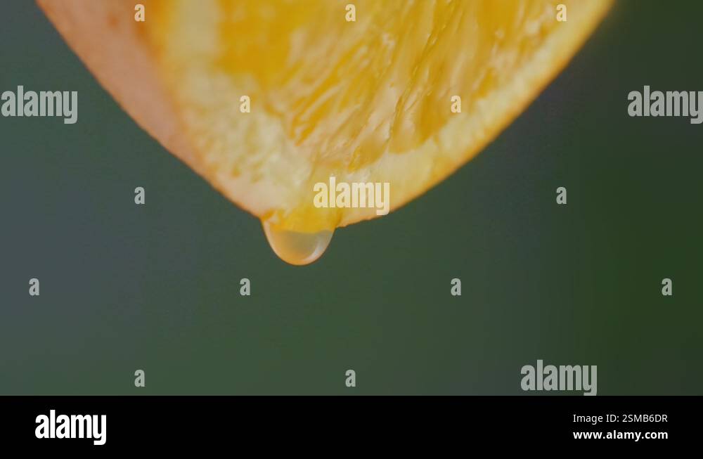 A Droplet of Juice Drips From an Orange Stock Video Footage - Alamy