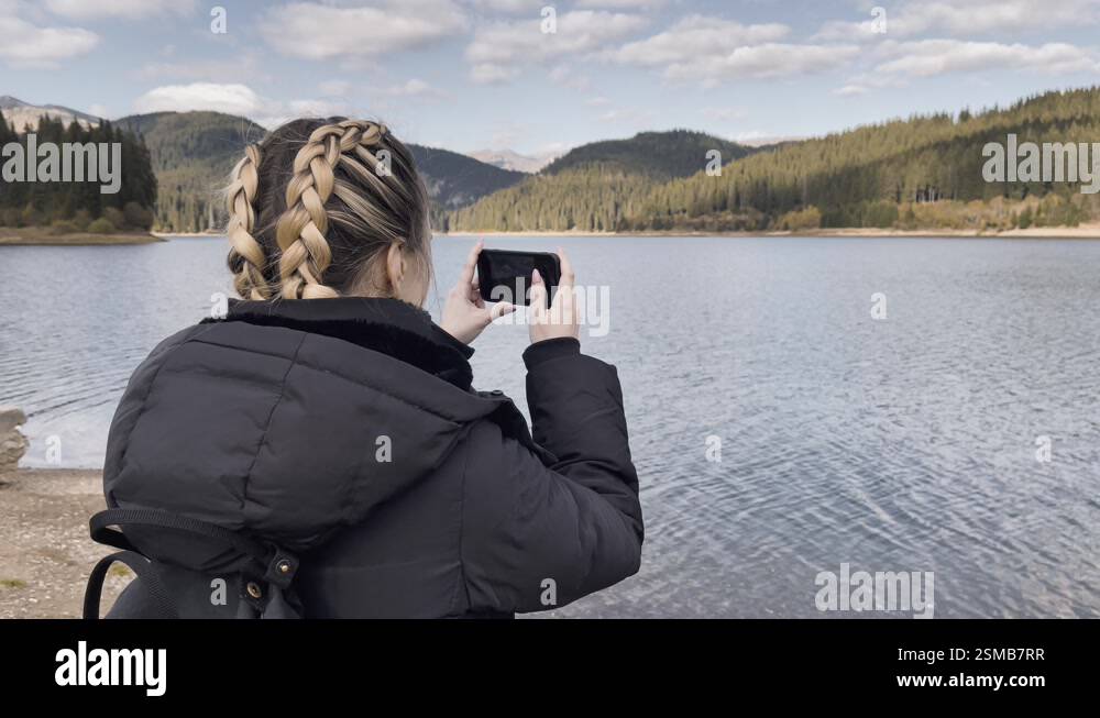 Woman With A Mobile Phone Taking A Picture Of Bolboci Lake In Romania ...