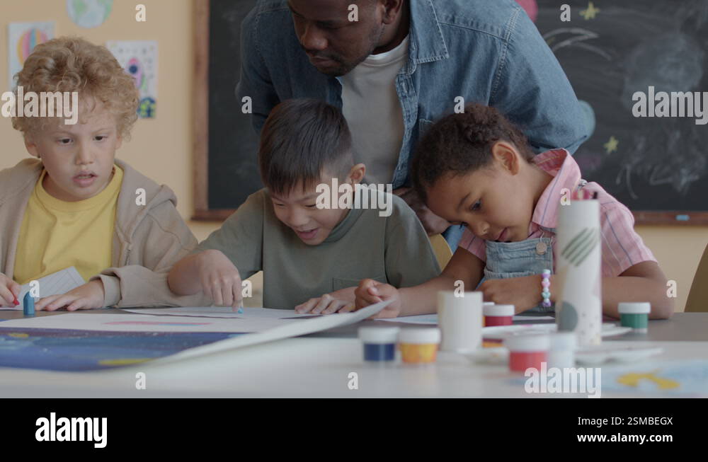 Kids Drawing with Crayons under Control of Teacher on Art Class Stock ...