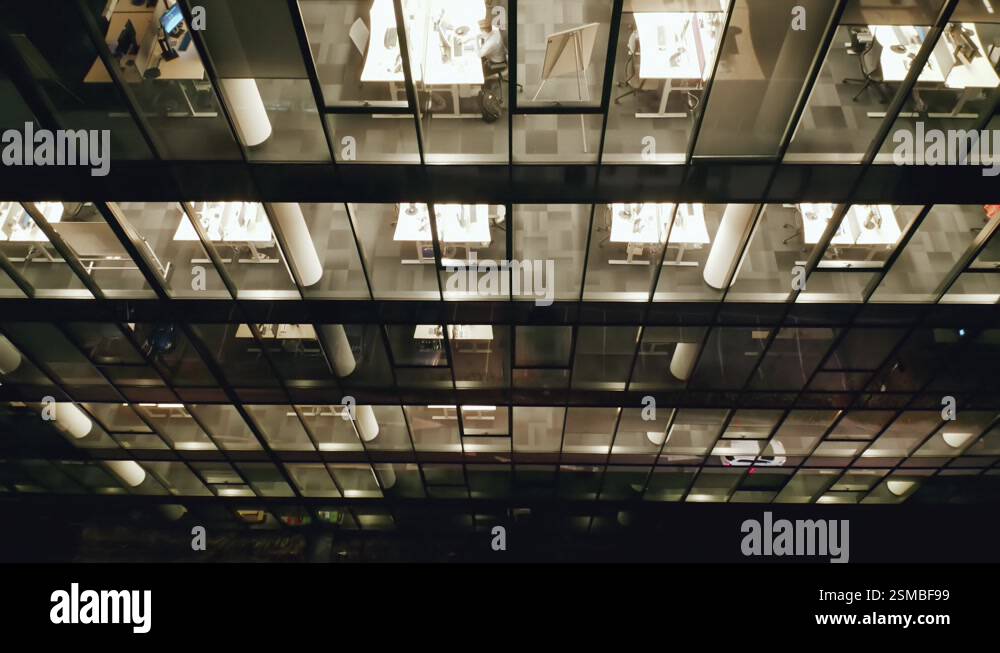 Cinematic drone shot of an office building evening with illuminated ...