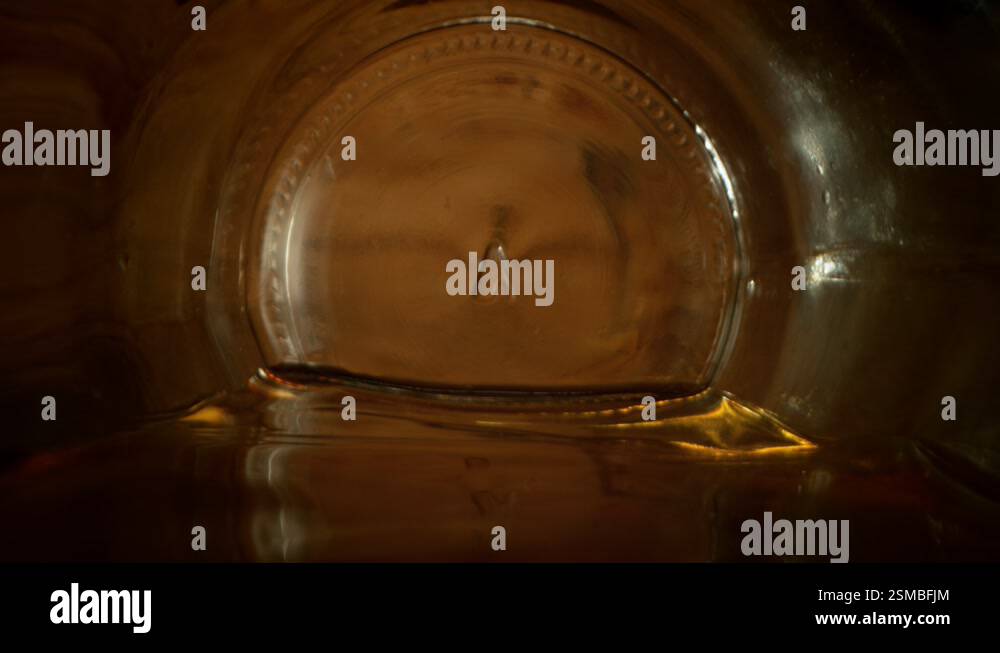 Super Slow Motion Macro Shot of Pouring Alcohol from Inside of Bottle ...