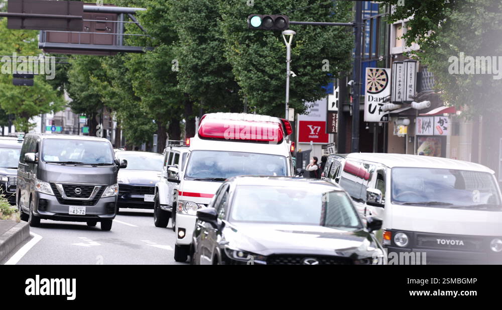 Emergency Vehicle Car Stuck in Traffic Tokyo Japan. Japanese Ambulance ...