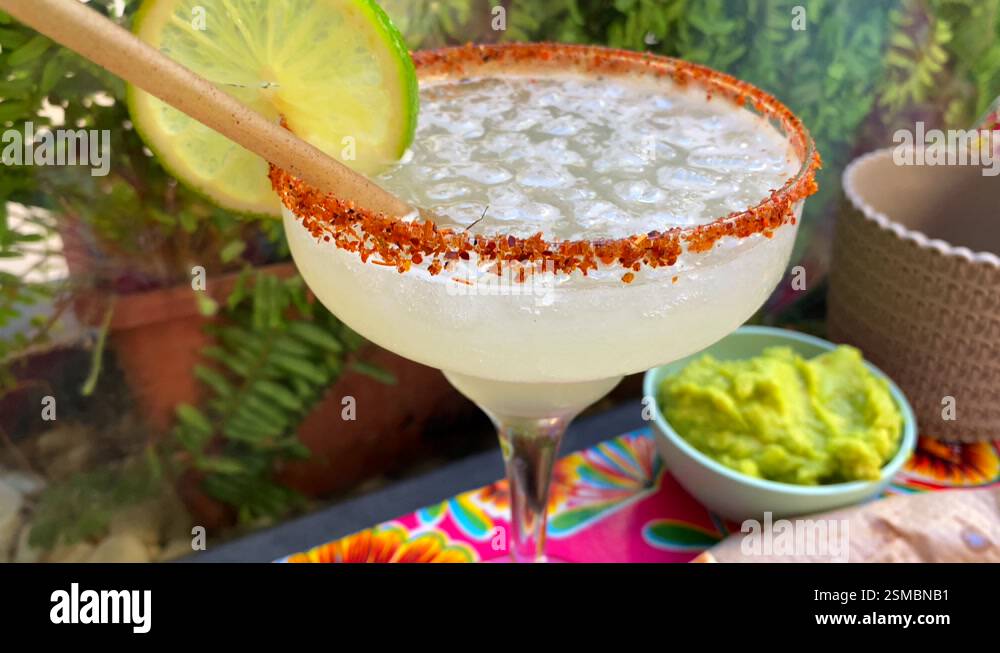 Spicy margarita mezcalita cocktail with tajin and a lime slice in a ...