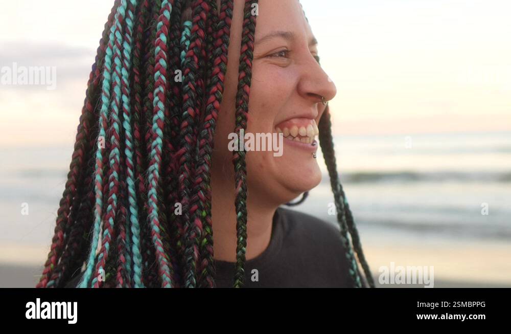 woman with braids laughs looking at camera on the beach Stock Video ...