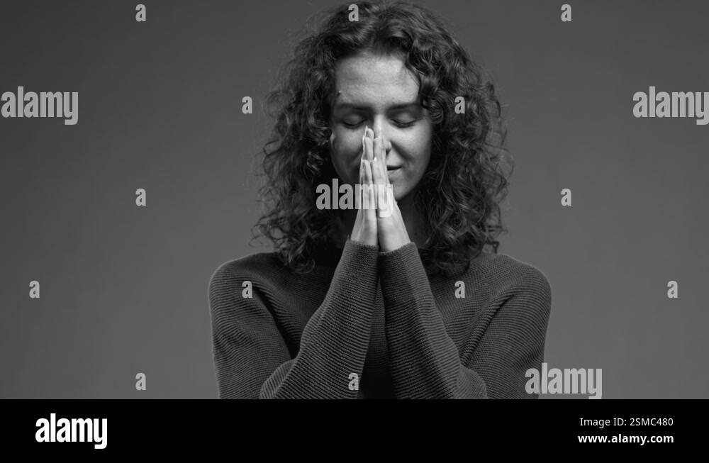 Faithful Young Woman Praying with Hope on dramatic black and white ...