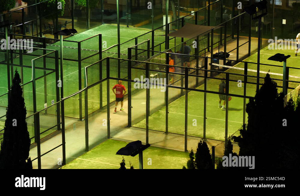 Padel Courts at Night with Players Playing on Lit Sport Fields, Static ...