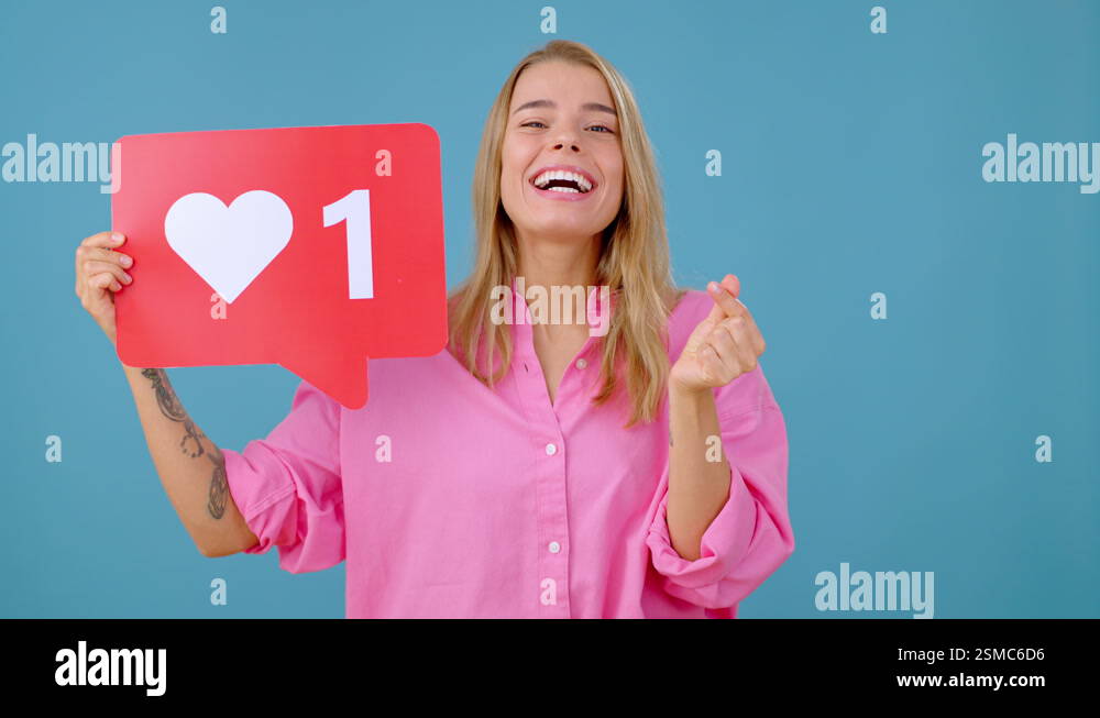 Woman holds sign with heart indicating appreciation for post Stock ...