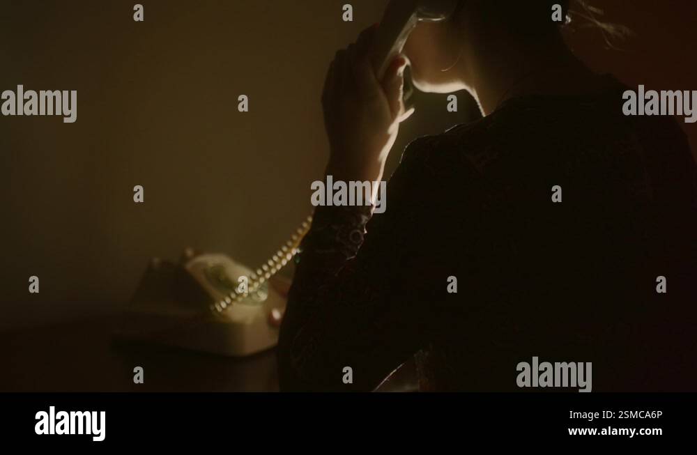 Late night gossip on the vintage landline telephone, shot from the back ...