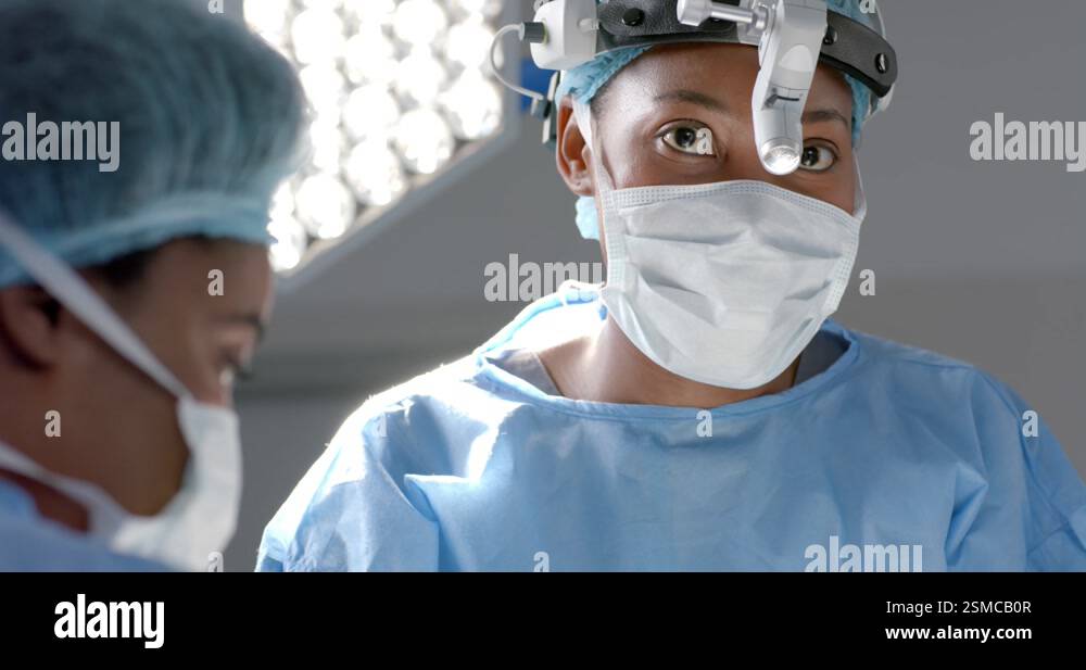 African american female surgeons operating on patient in operating ...